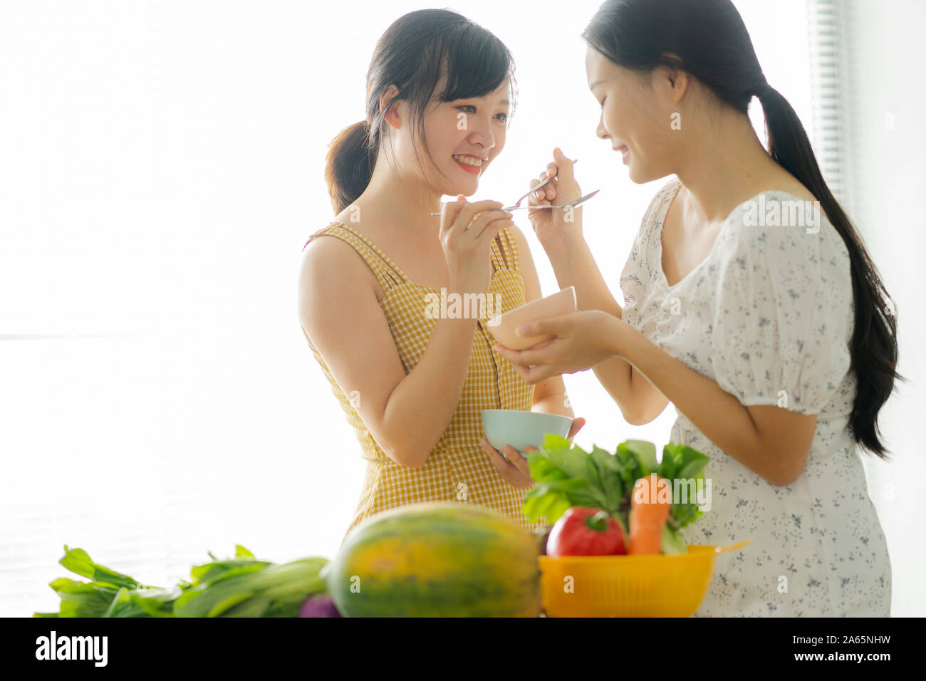 Pretty girls cooking in the kitchen Stock Photo - Alamy