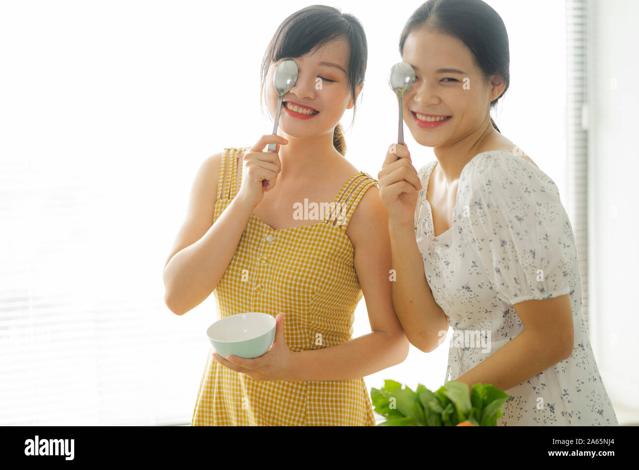 Pretty girls cooking in the kitchen Stock Photo - Alamy