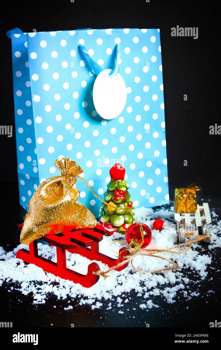 Gift bag, wooden sledges, golden sack with gifts and colorful fur tree ...