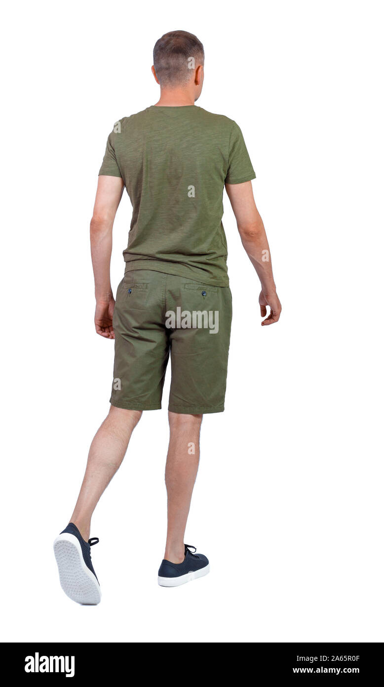 Back view of going handsome man in shorts. walking young guy . Rear ...