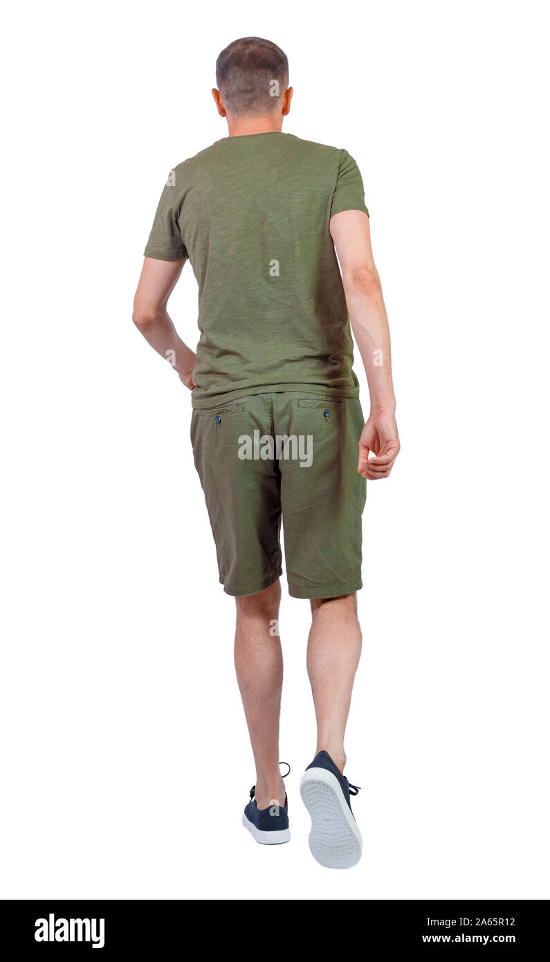 Back view of going handsome man in shorts. walking young guy . Rear ...