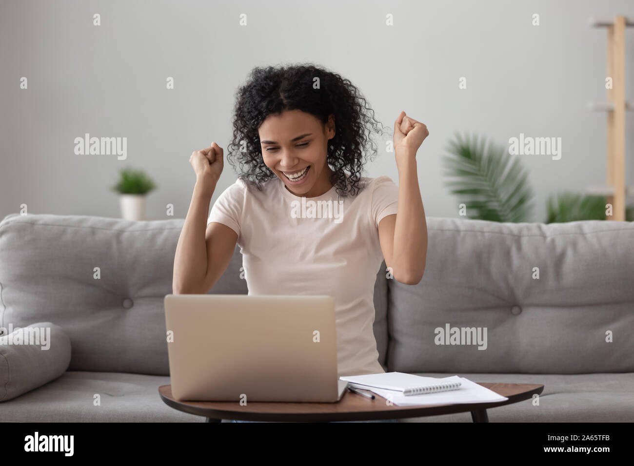 Happy biracial woman excited reading pleasant email on laptop Stock ...