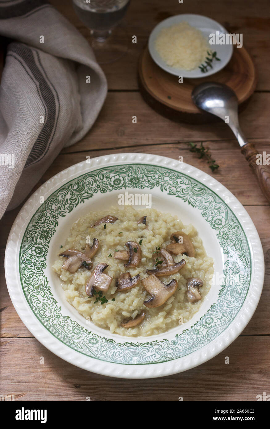 Traditional italian dish risotto with champignons in a light plate on a ...