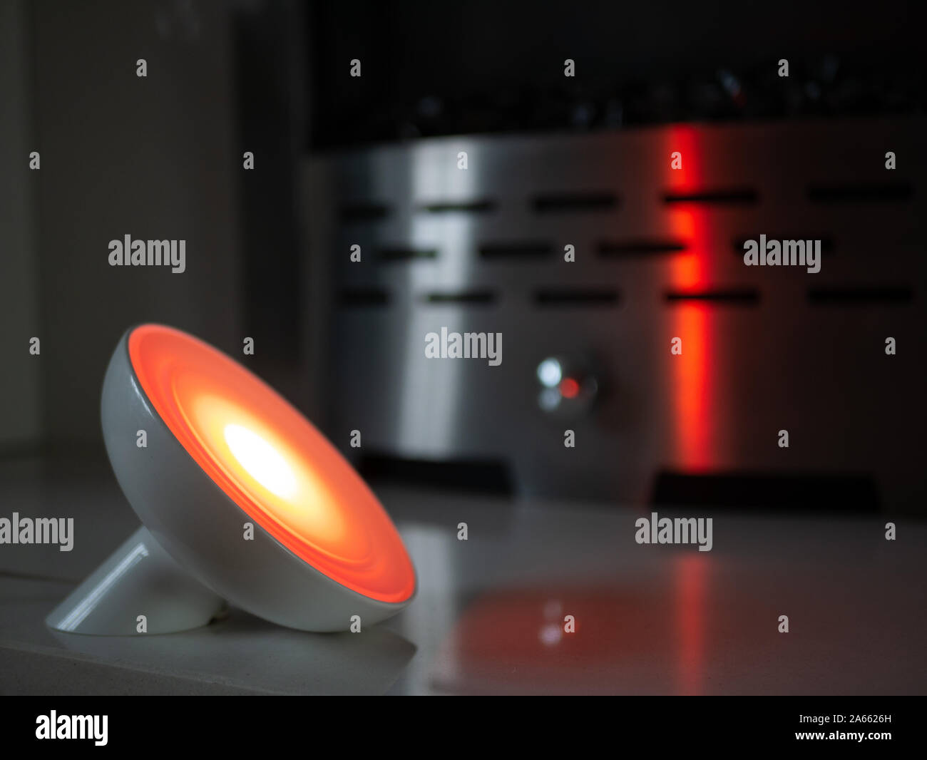 Smart home lamp light with coloured LED on fireplace - Orange Stock ...