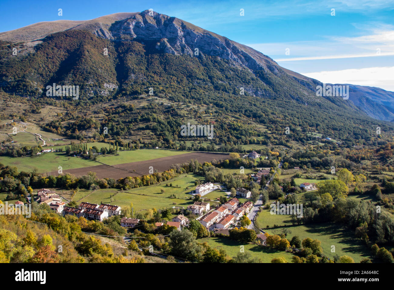 landscape of a sunny valley and mountain peaks as seen from the town of ...