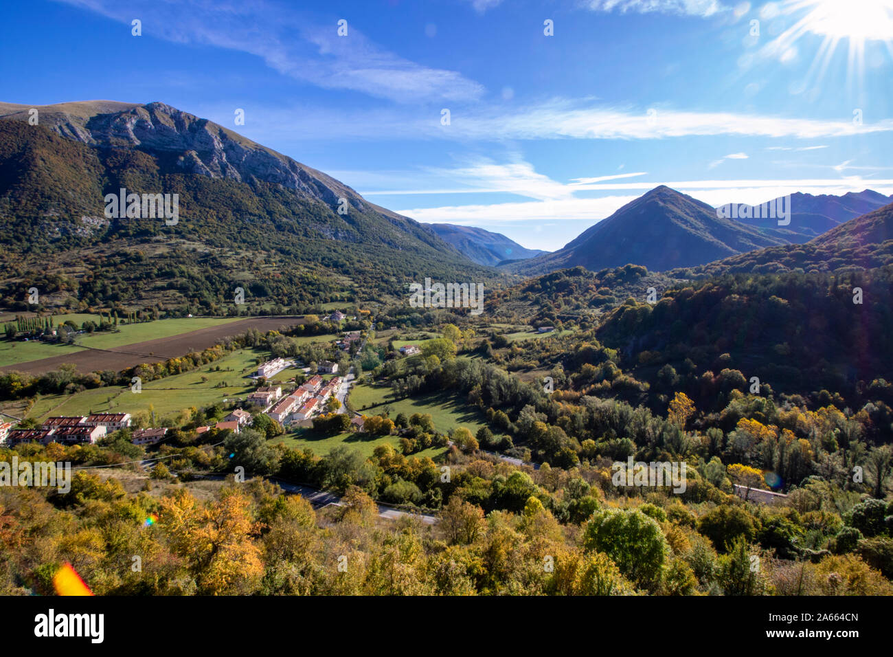 landscape of a sunny valley and mountain peaks as seen from the town of ...