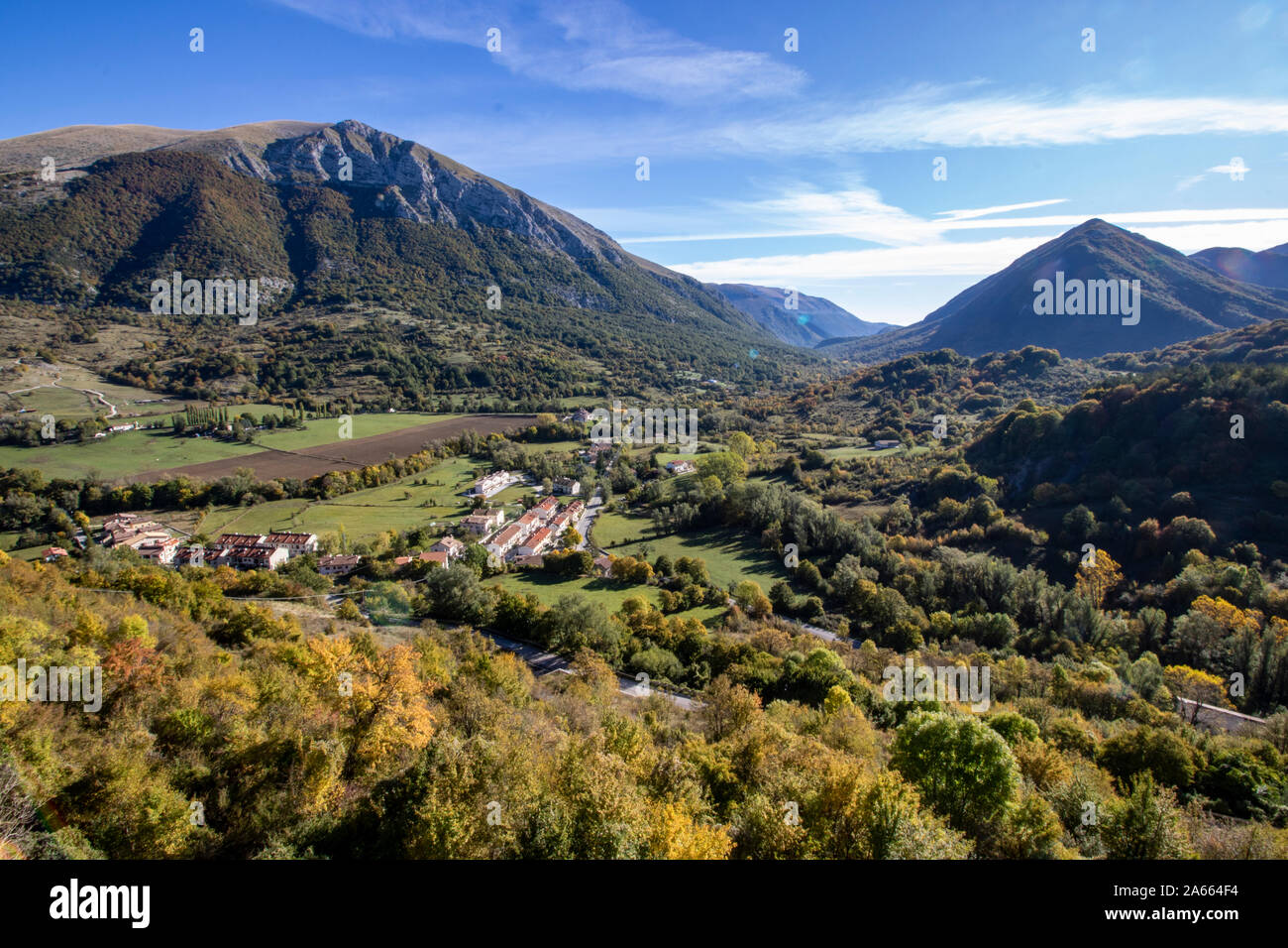 landscape of a sunny valley and mountain peaks as seen from the town of ...