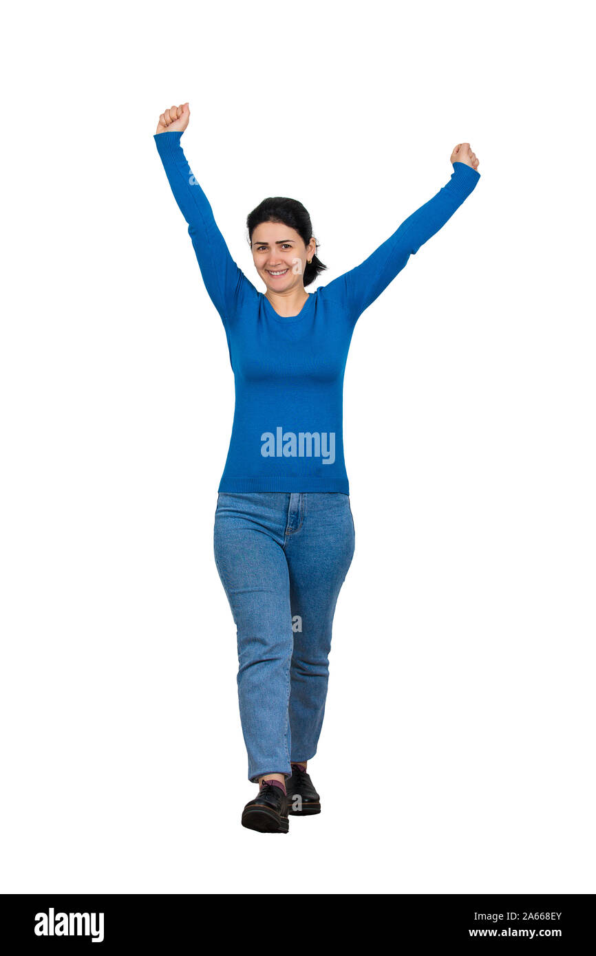 Full length portrait of a cheerful young woman, raising hands up as ...