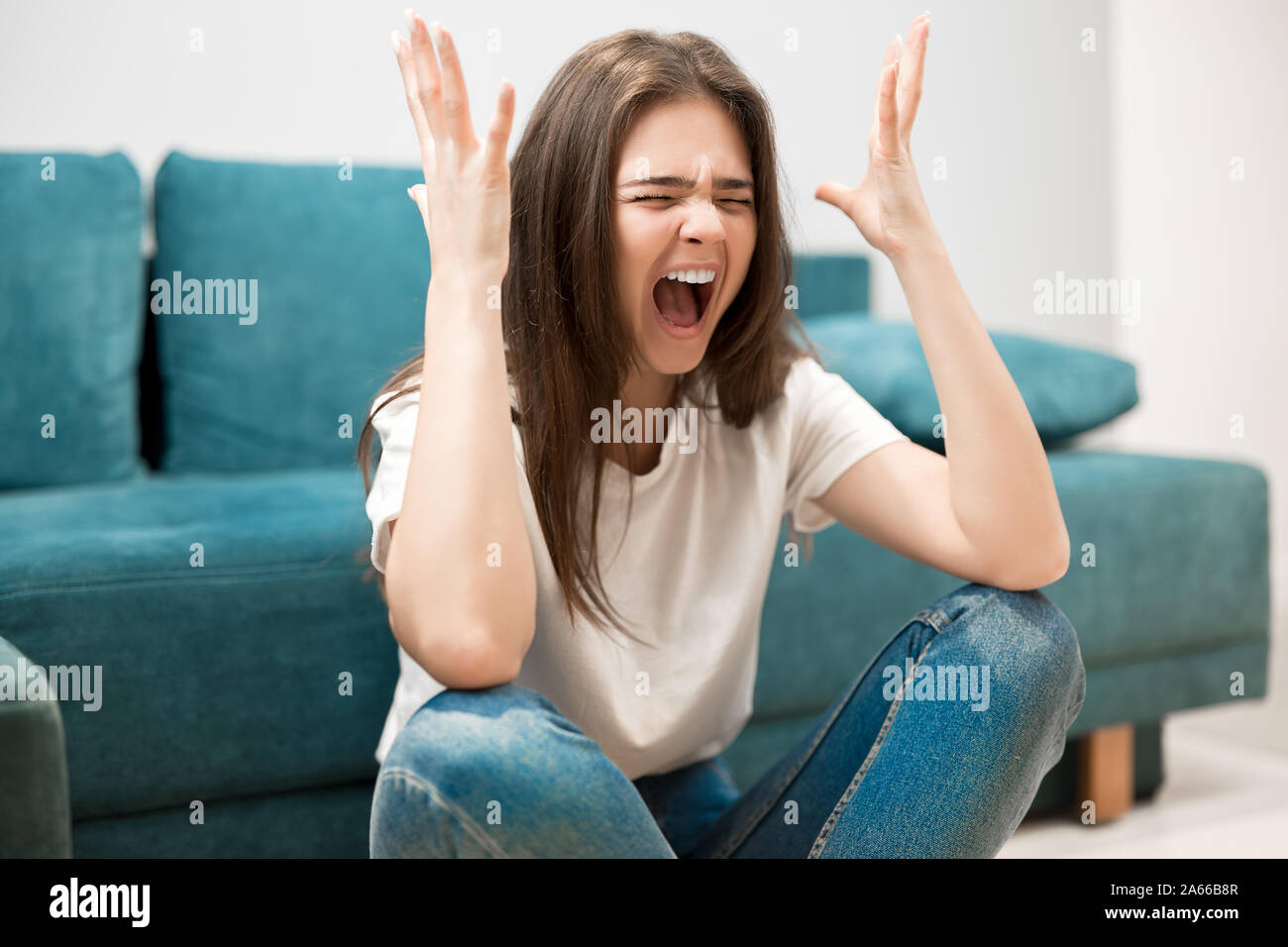 beautiful young woman crying feeling very depressed sitting on floor ...
