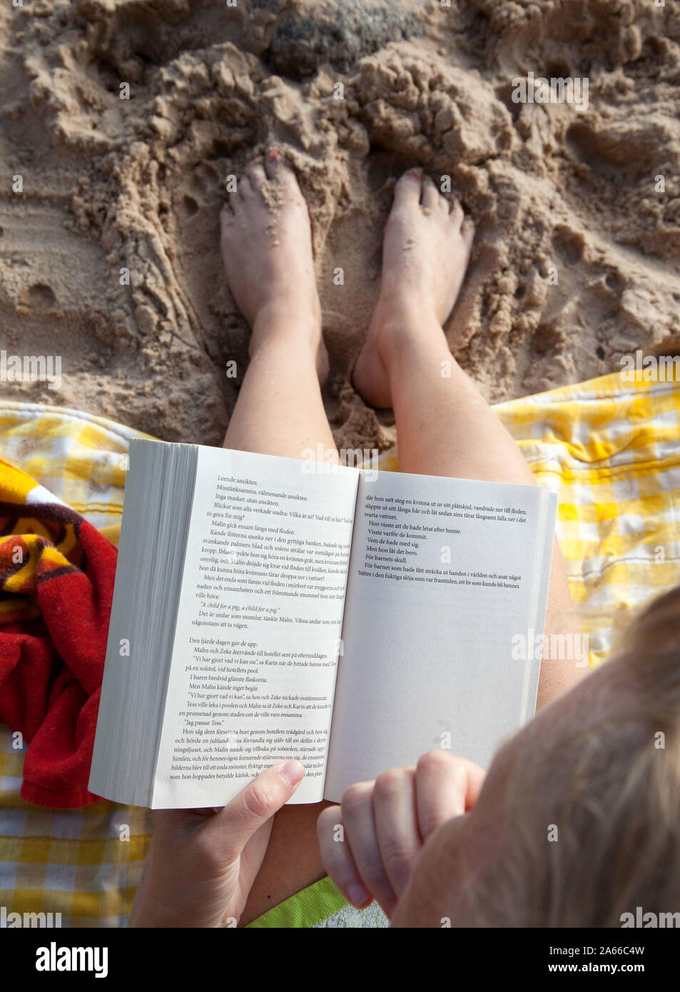 Someone reading a book on the beach.Photo Jeppe Gustafsson Stock Photo ...