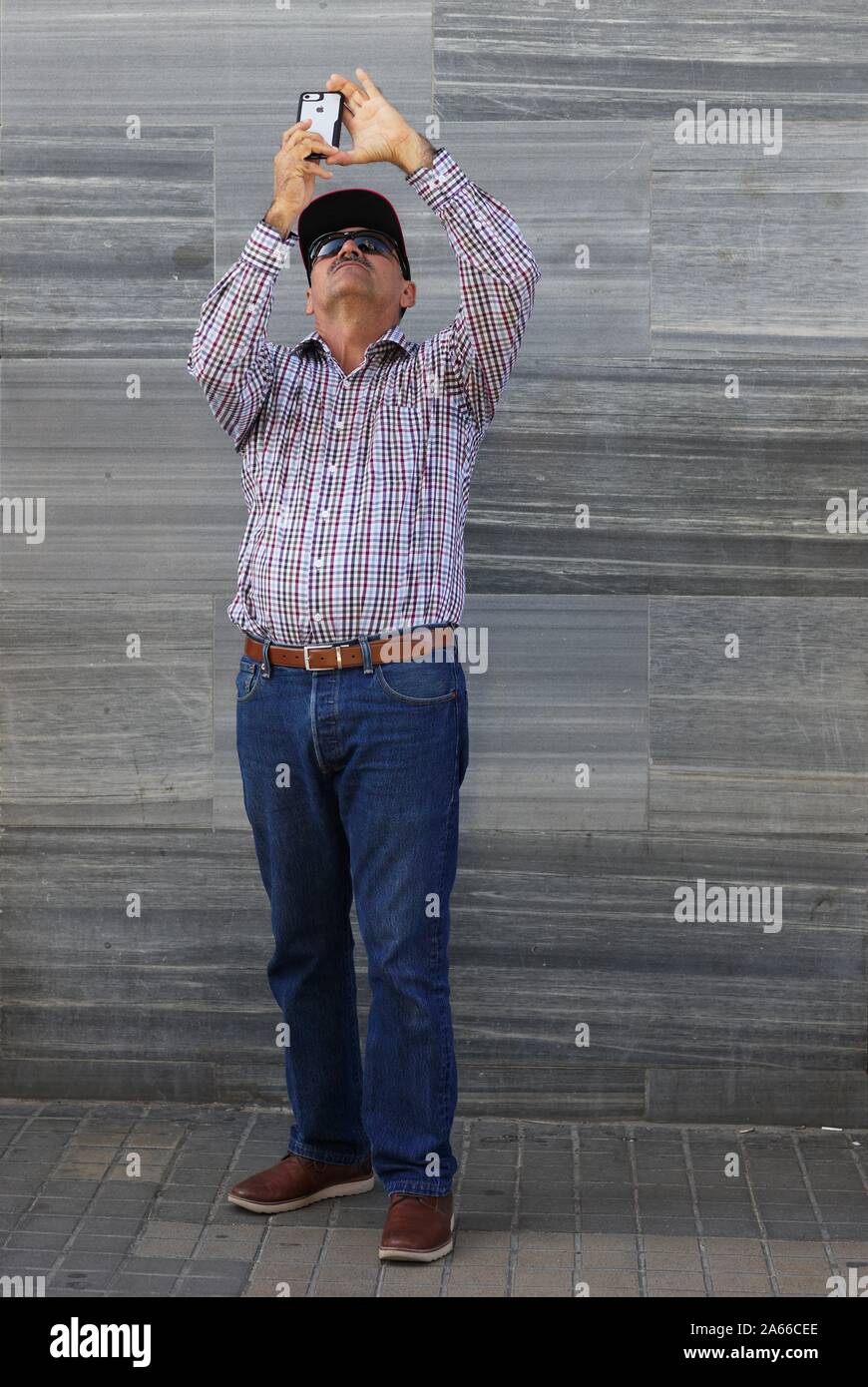 Man taking photo with mobile phone Stock Photo - Alamy