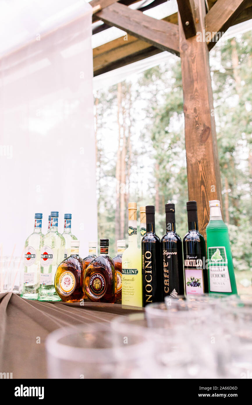 Table with glasses and alcohol bottles on background. Celebration ...