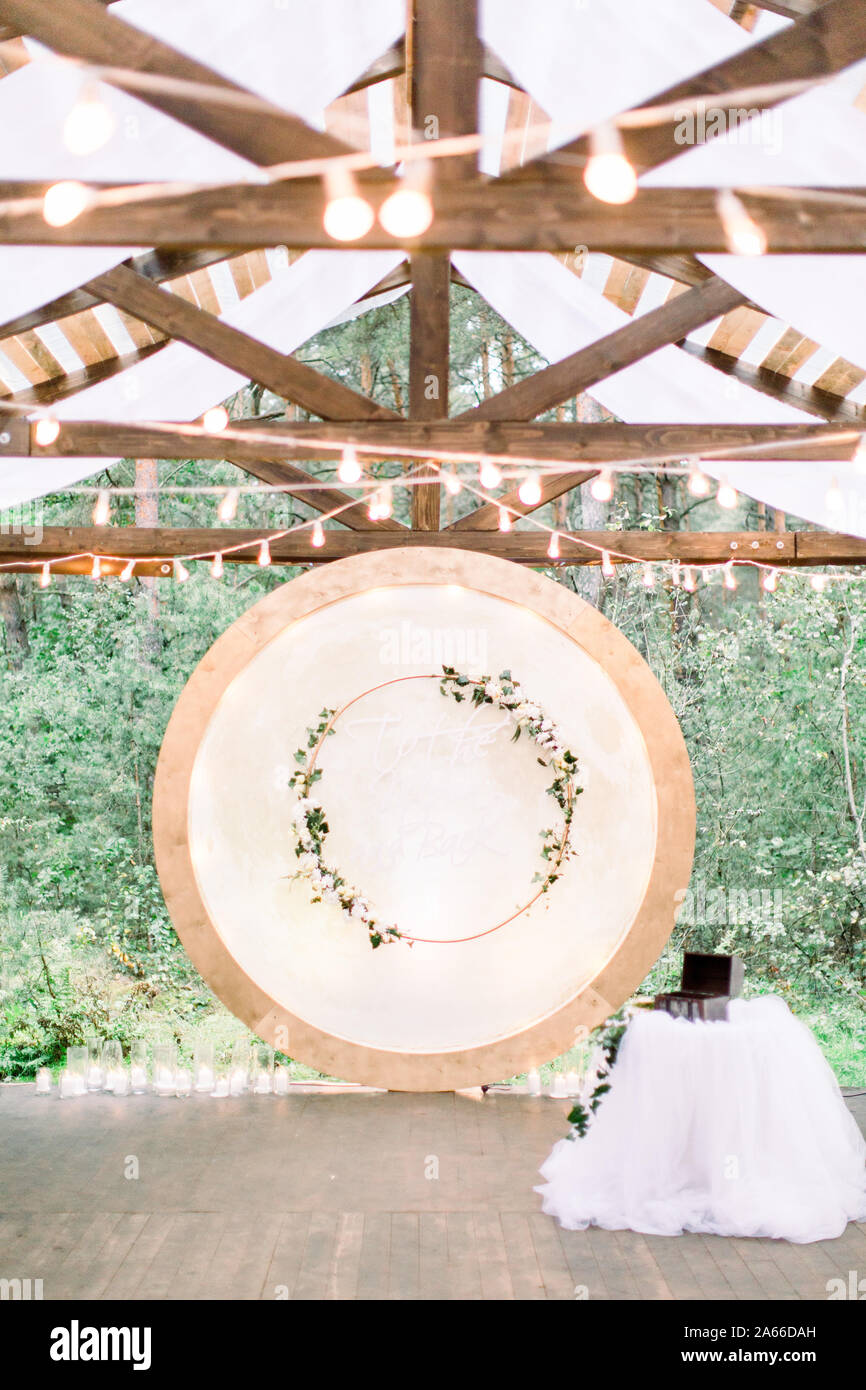 Wedding round arch in rustic style decorated with wreath from flowers ...