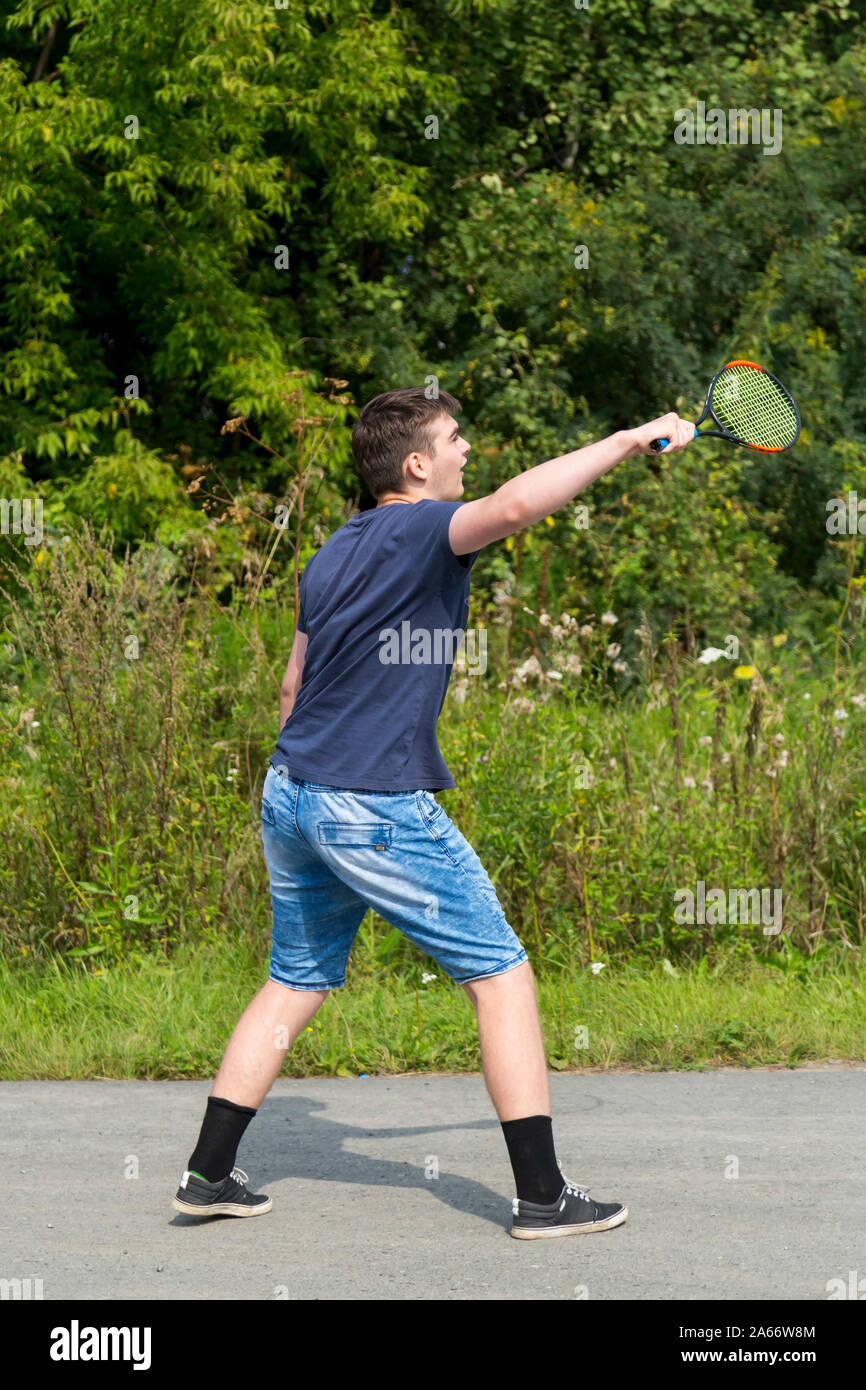 Teen boy with a racket in hand plays badminton Stock Photo - Alamy
