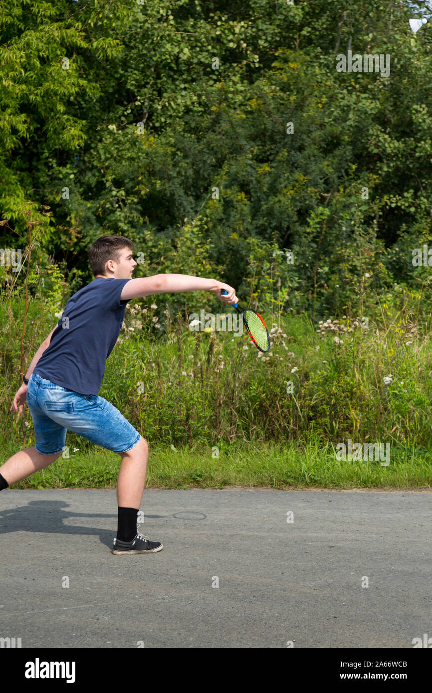 Teen boy with a racket in hand plays badminton Stock Photo - Alamy