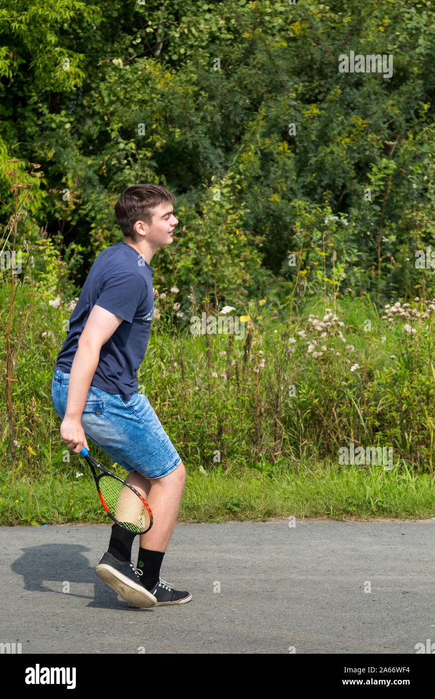 Teen boy with a racket in hand plays badminton Stock Photo - Alamy