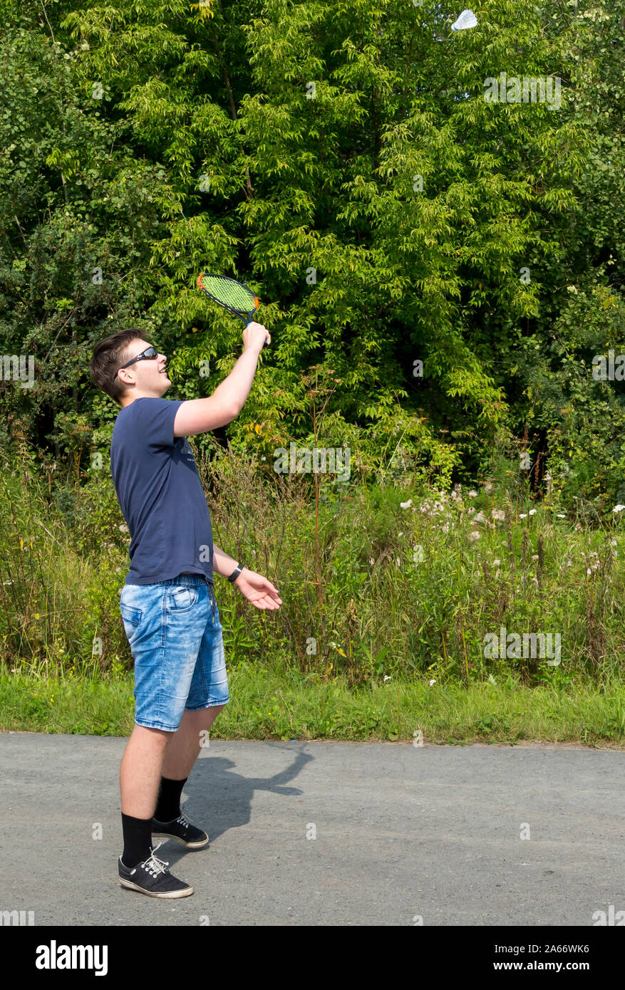 Teen boy with a racket in hand plays badminton Stock Photo - Alamy