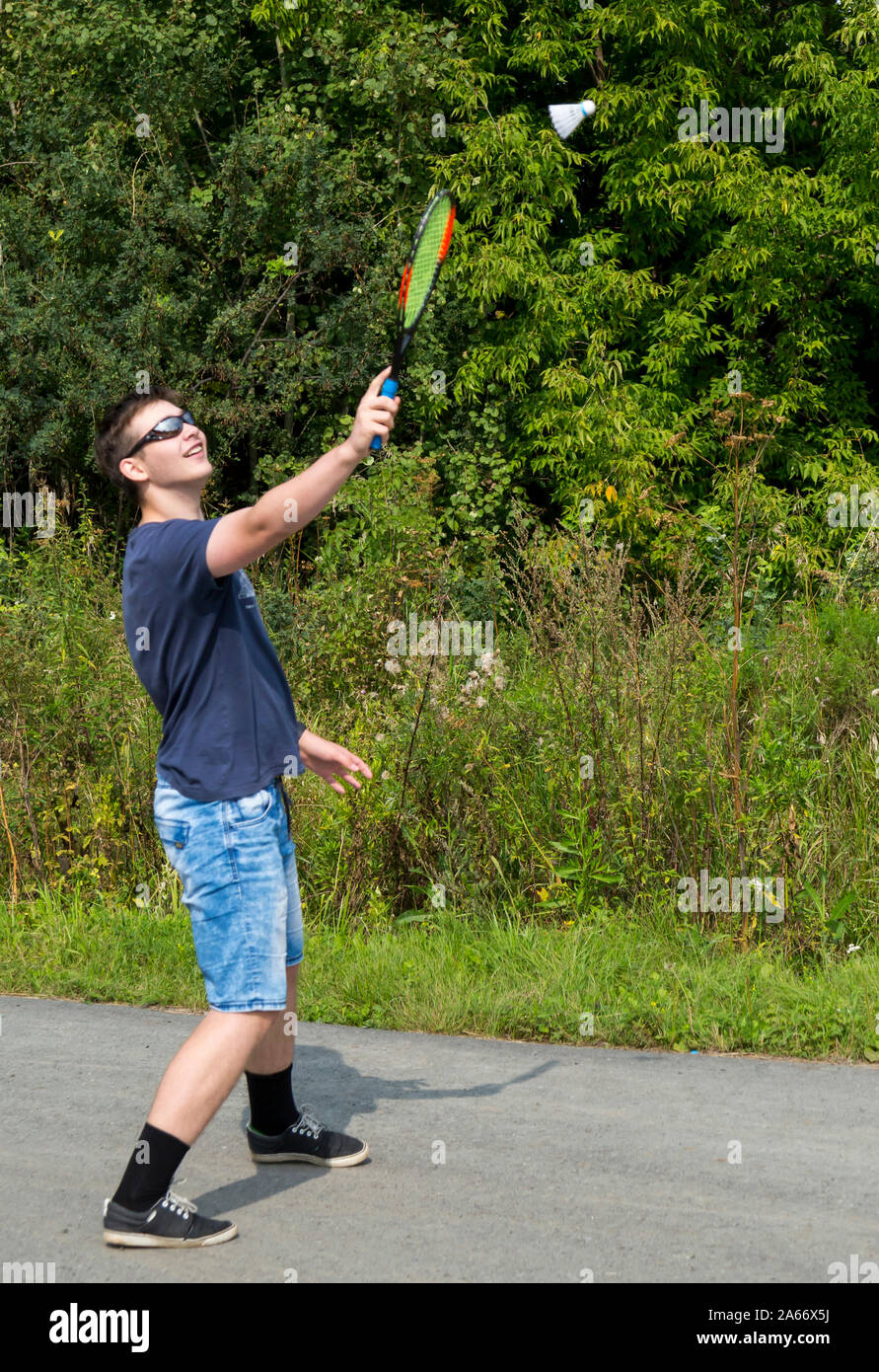 Teen boy with a racket in hand plays badminton Stock Photo - Alamy