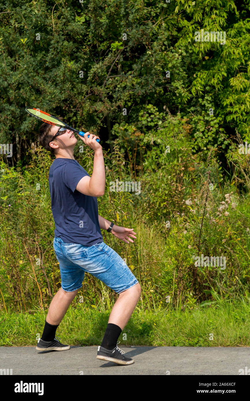 Teen boy with a racket in hand plays badminton Stock Photo - Alamy