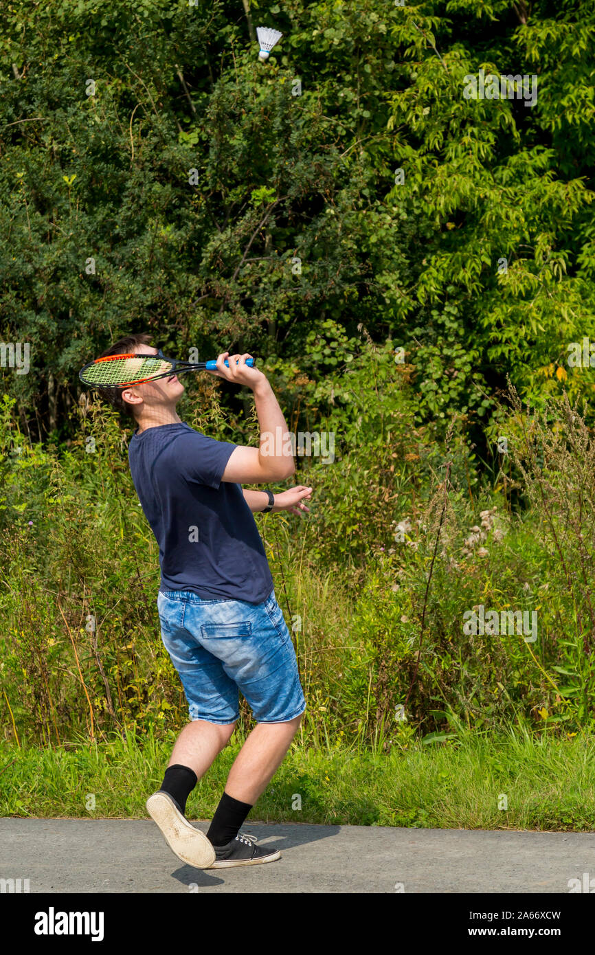 Teen boy with a racket in hand plays badminton Stock Photo - Alamy