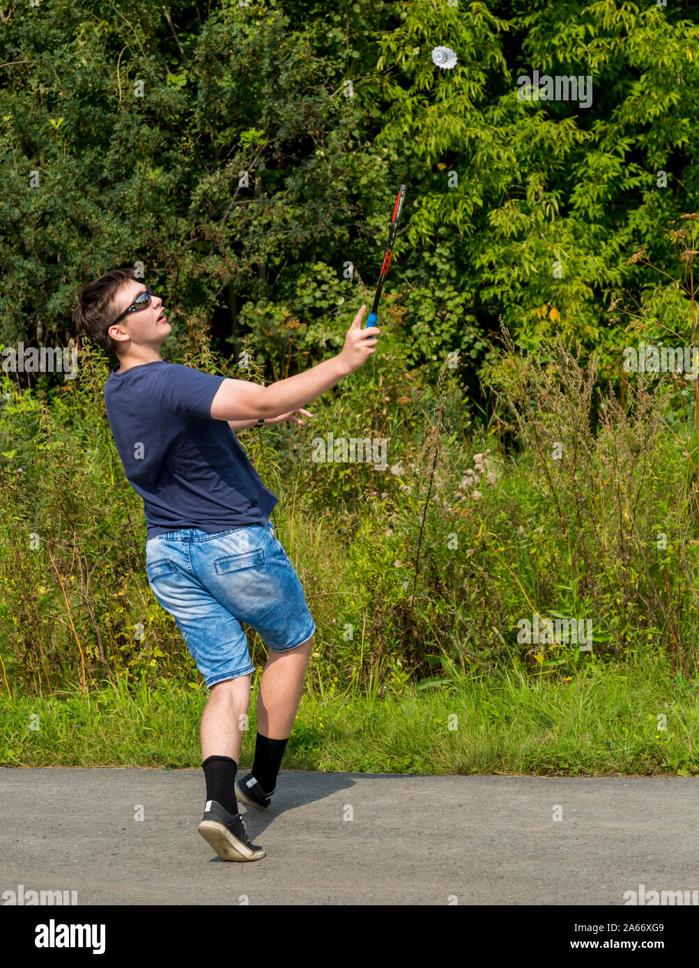 Teen boy with a racket in hand plays badminton Stock Photo - Alamy