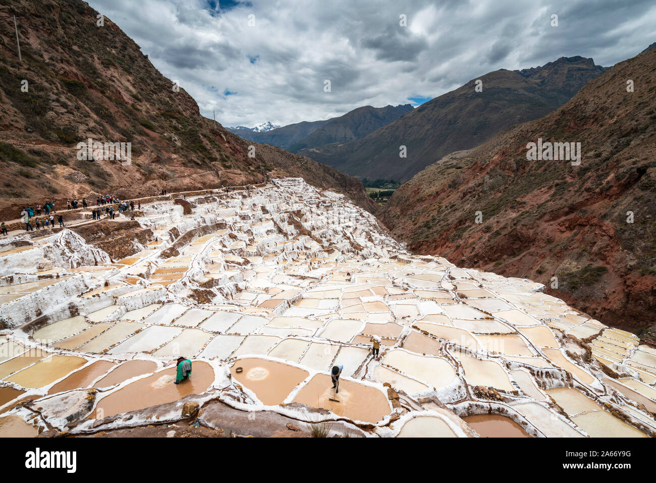 Elevated view of workers at Maras salt marsh terraces, Salinas de Maras ...