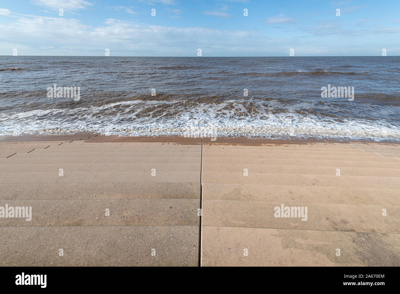 Sea waves breaking on the promenade steps in Blackpool, Lancashire, UK ...