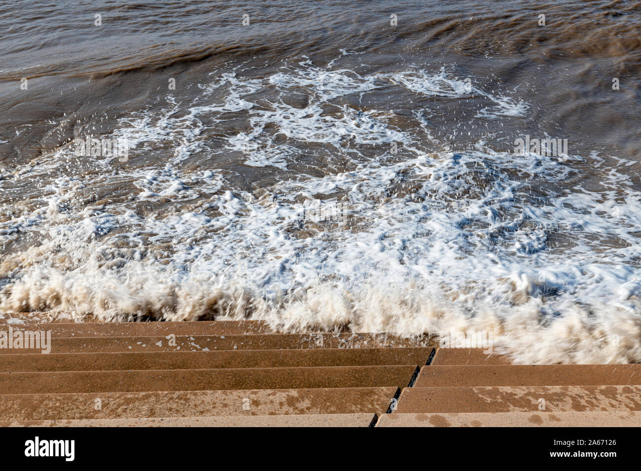Sea waves breaking on the promenade steps in Blackpool, Lancashire, UK ...