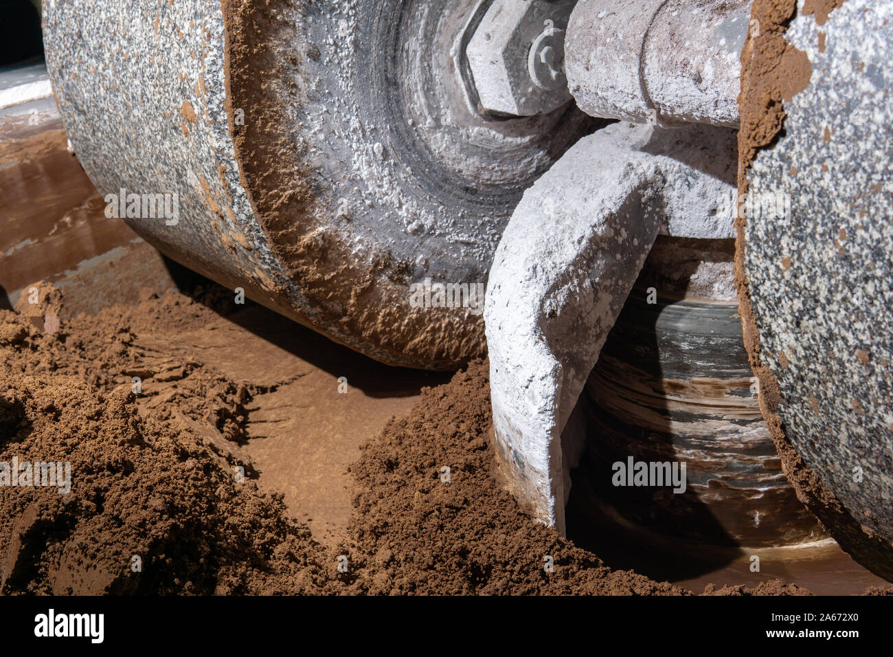 millstone of industrial melanger grind and mix cocoa and other ...