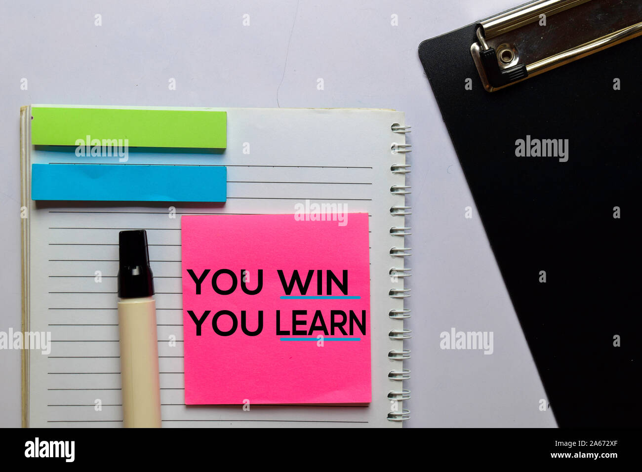 You Win You Learn write on sticky notes. Isolated on white table ...