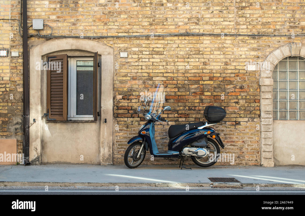 Typical italian motorbike in front of old house facade. Traditional ...
