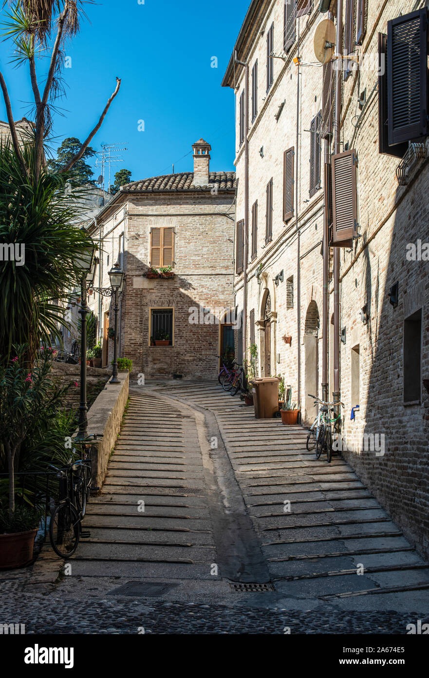 Old buildings on small italian street. Narrow street in Italy. Flowers ...