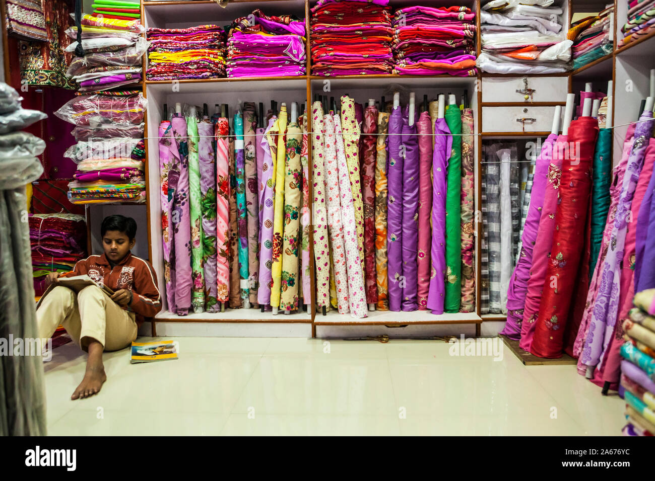 A boy studying in a textile shop, Jodhpur, Rajasthan, India Stock Photo ...