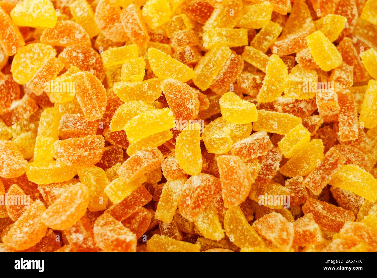 background - golden yellow translucent fruit gumdrops in sugar Stock ...