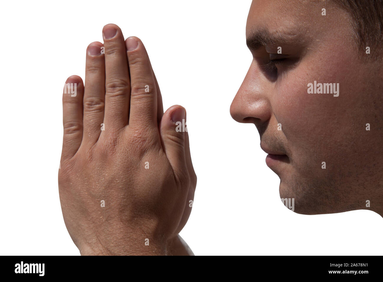 A praying young man. A person during prayer with hands folded to pray ...