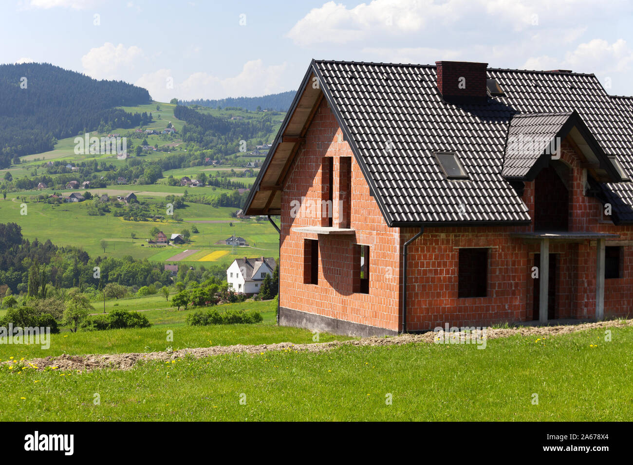 A new two story house in mountains Stock Photo - Alamy