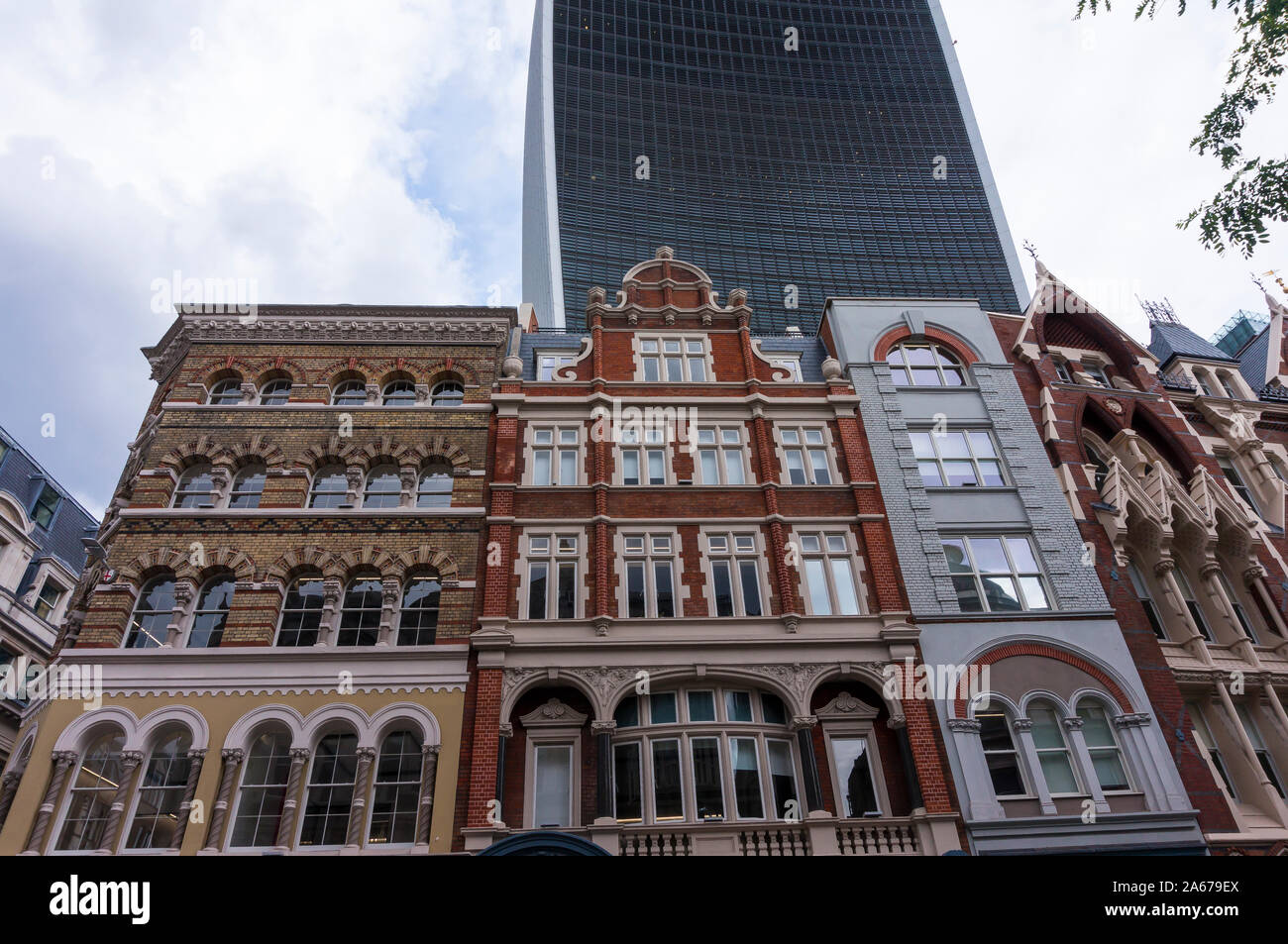 Classic architecture in City of London with skyscrapers in background ...