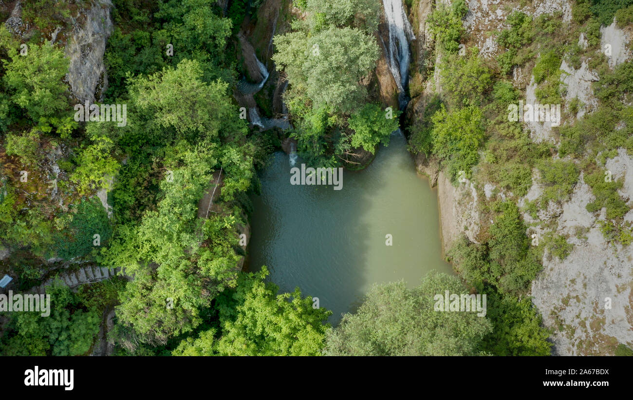 Top view of waterfall in a lake in the middle of de forest. Arial view ...