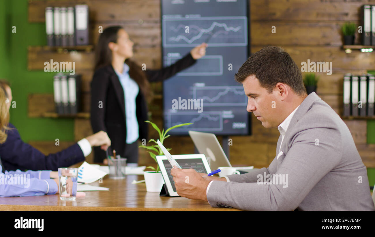 Businessman working in the conference room holding chars. Coworker ...