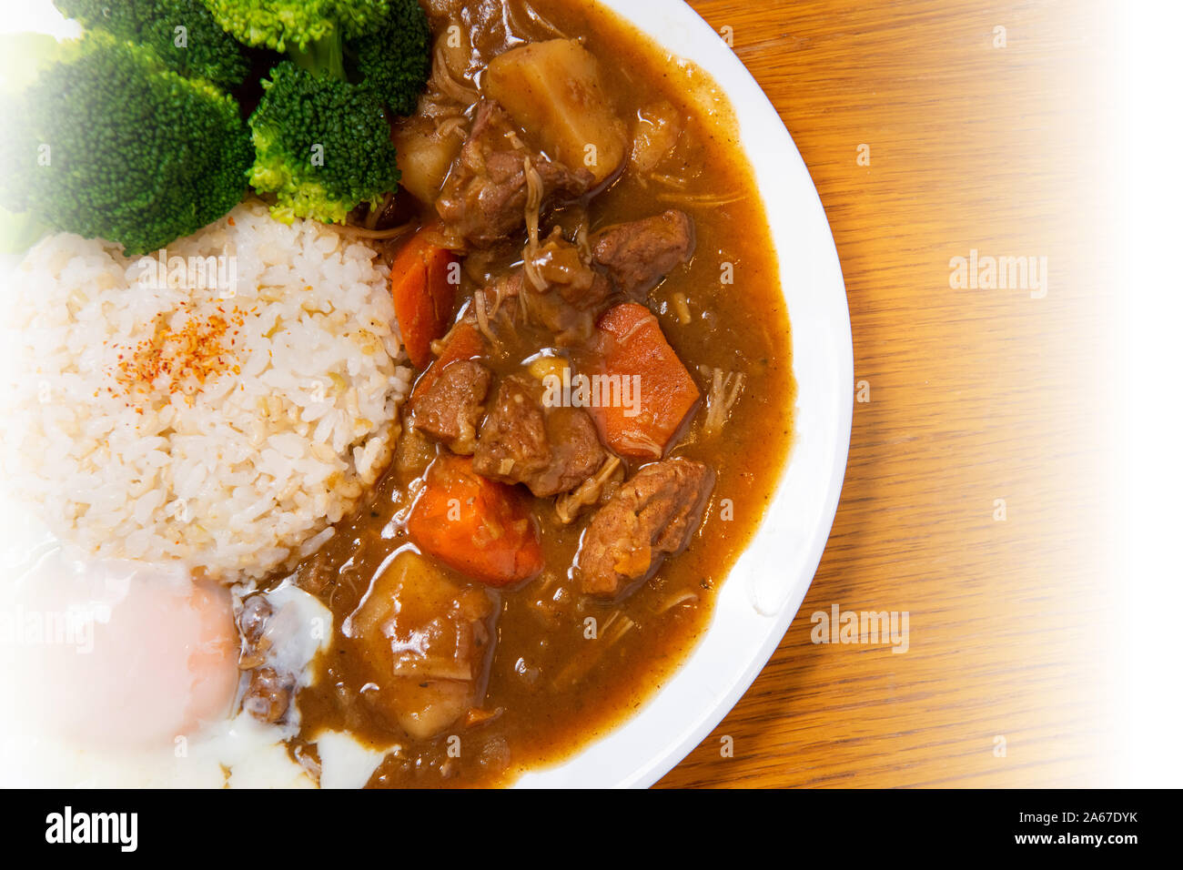 Pork Curry Rice on wooden background ( Onsen tamago, Potato, enoki ...