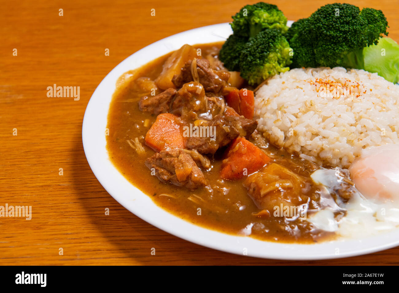 Pork Curry Rice on wooden background ( Onsen tamago, Potato, enoki ...