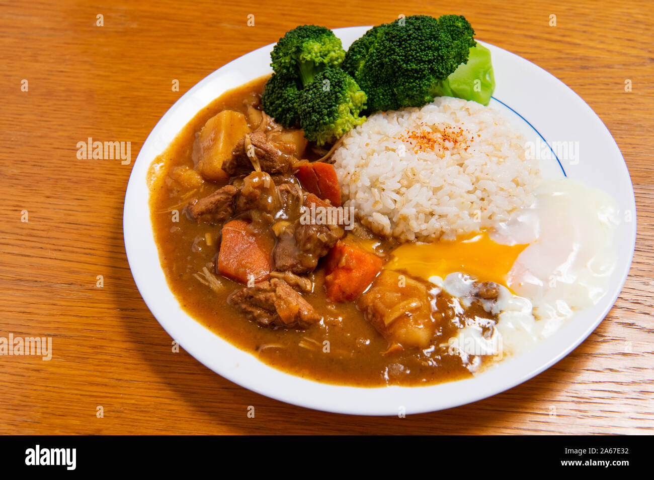 Pork Curry Rice on wooden background ( Onsen tamago, Potato, enoki ...