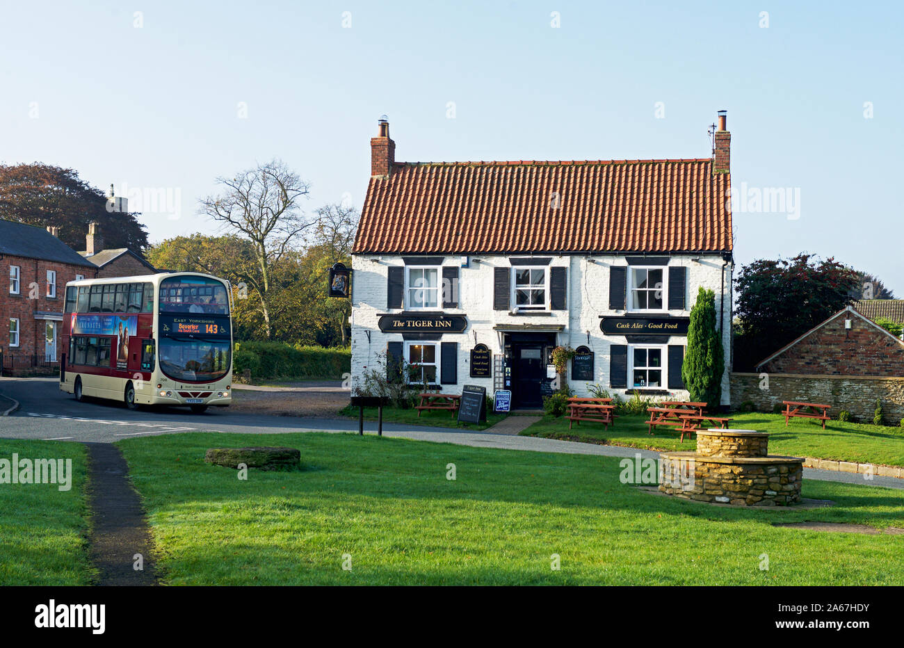 Bus passing the Tiger Inn, in the village of North Newbald, East ...
