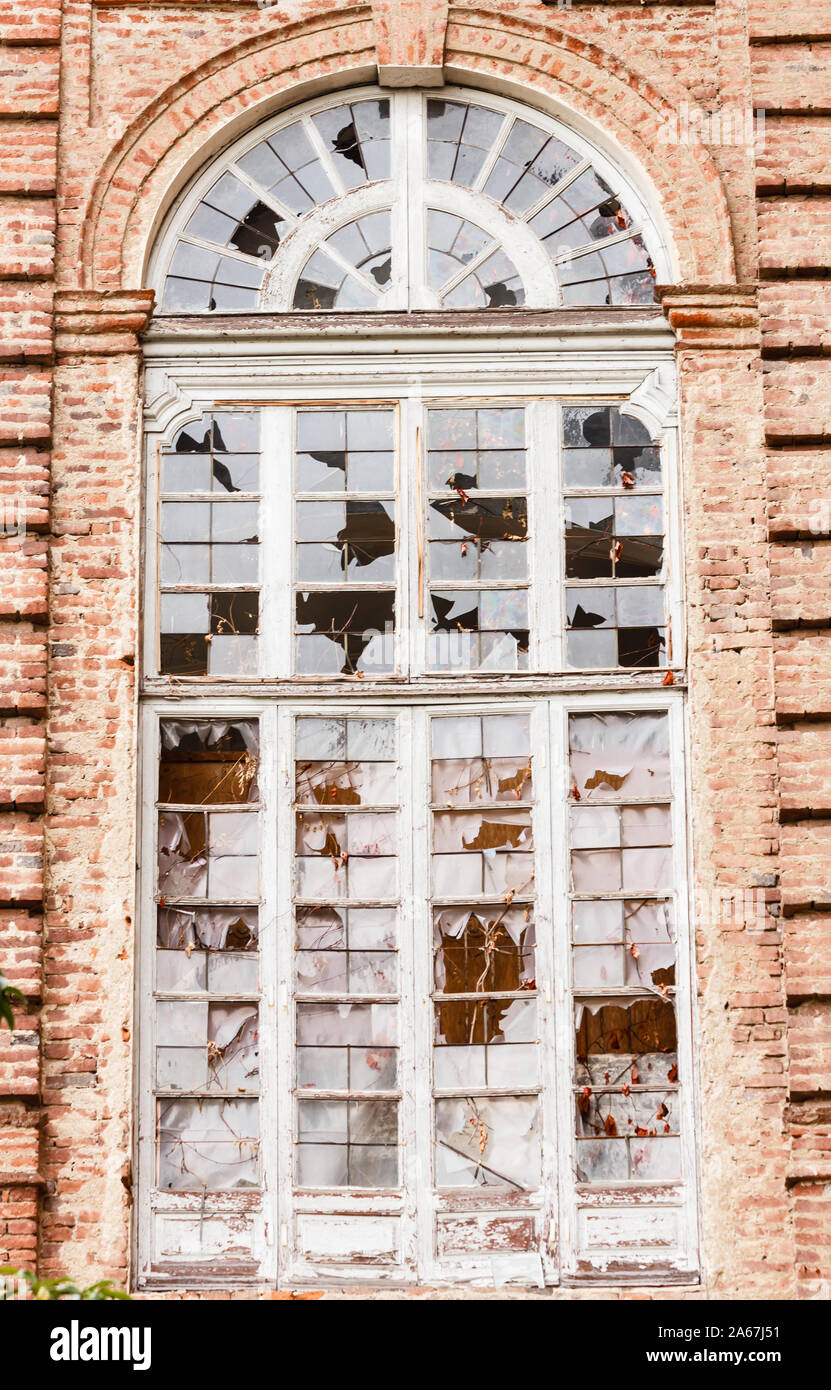 a large window full of broken glass /an ancient window with broken ...