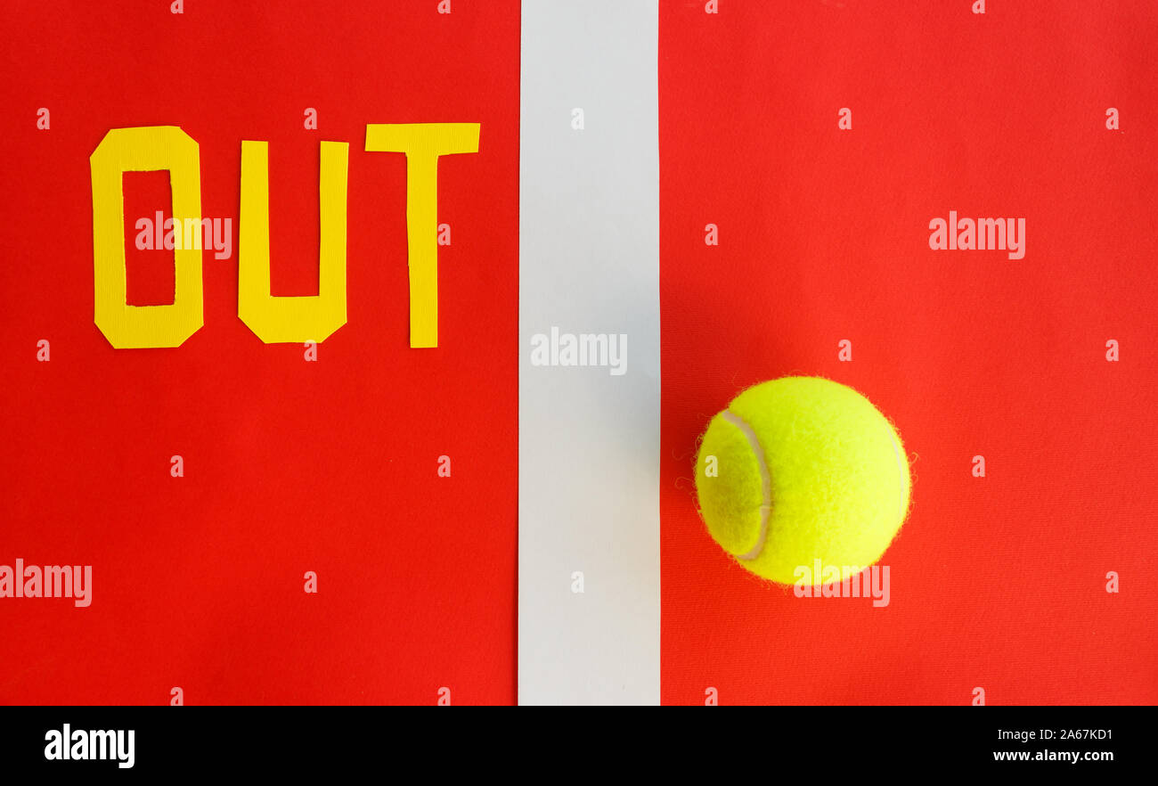 the inscription out next to a line of a tennis court with a tennis ball ...