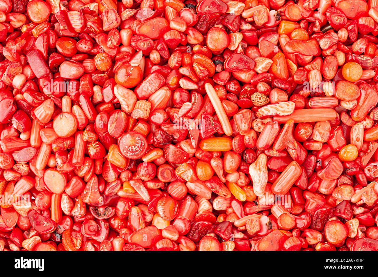 Small stones rounded red coral texture background Stock Photo - Alamy