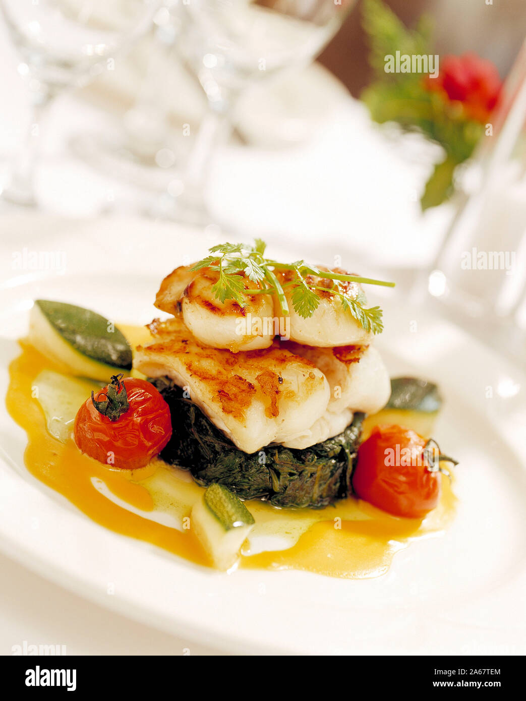 Still life. Food. Fish dish. Roasted cod with seared scallops on a bed ...