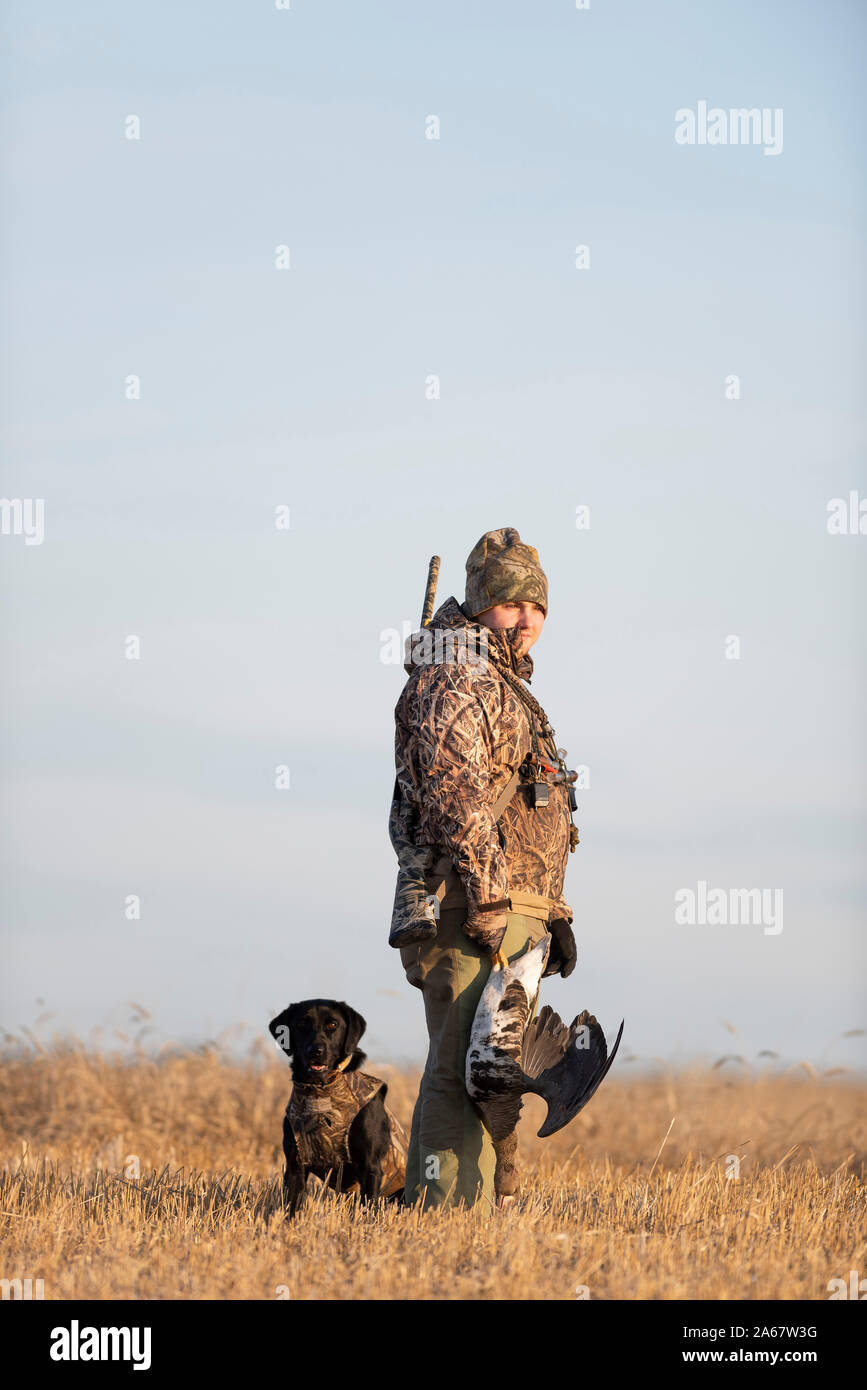 A Young Goose hunter with his Black Labrador Retriever Stock Photo - Alamy