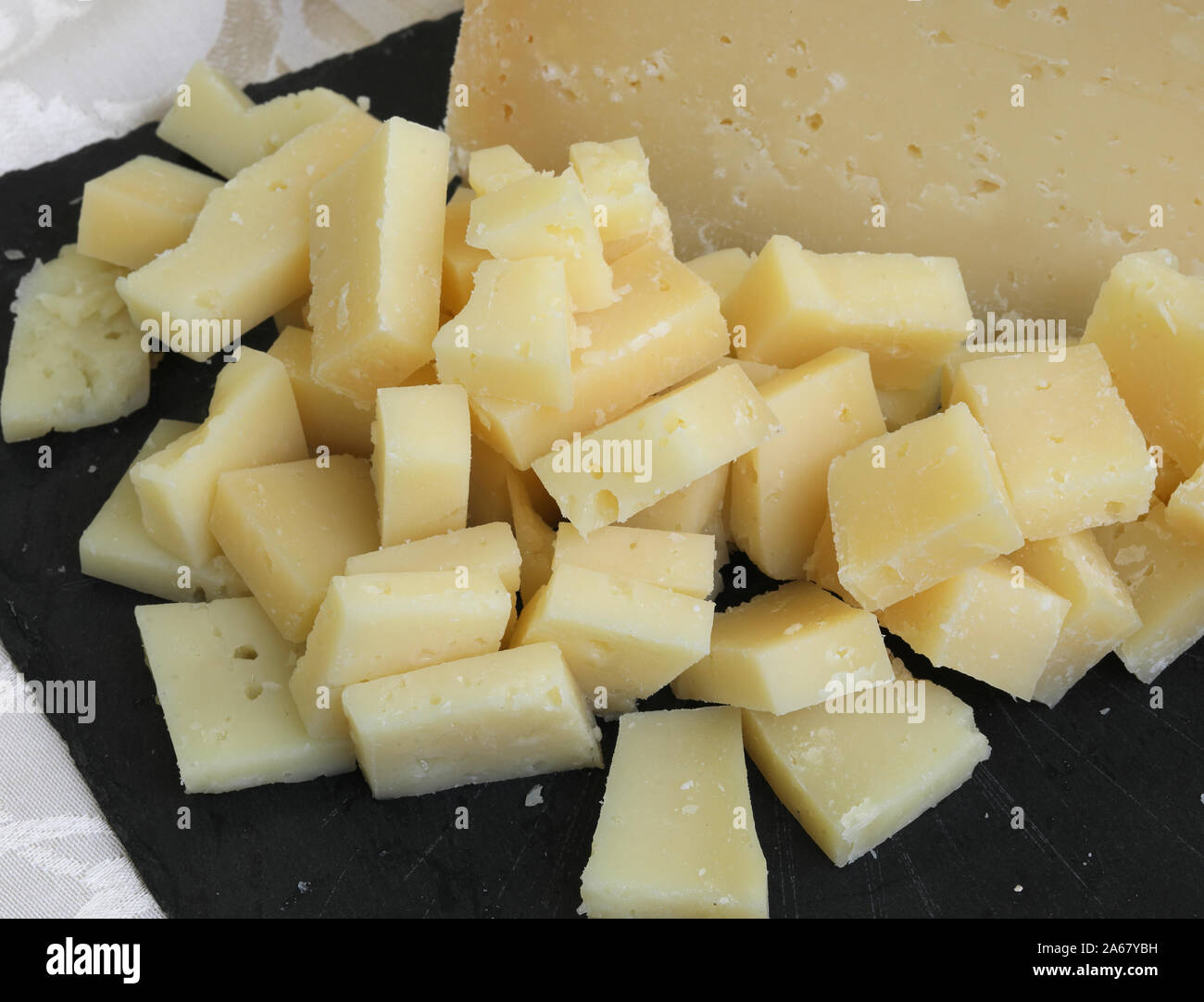 many small pieces of aged cheese and the black slate at cheese factory ...