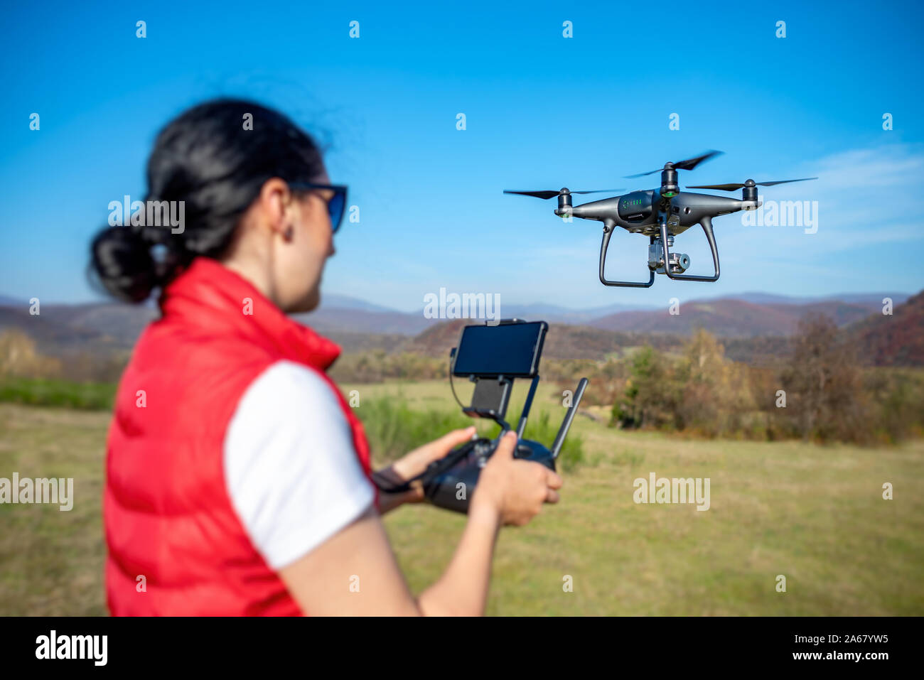 Woman controls drone Stock Photo - Alamy